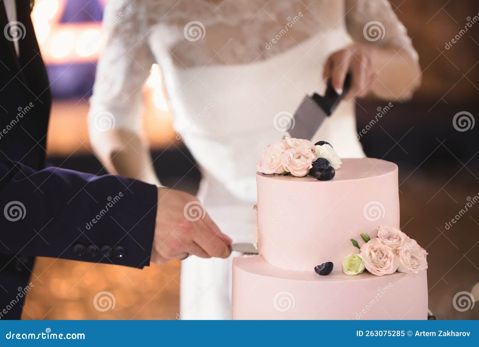 The Bride and Groom Cut a Gorgeous Wedding Cake at a Banquet. Stock ...