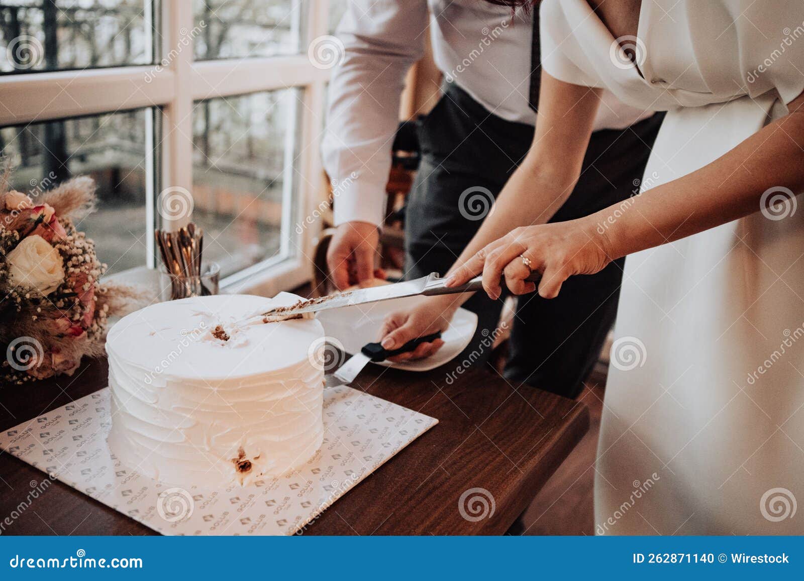 Bride and Groom Cutting a Slice of the Wedding Cake Stock Photo - Image ...