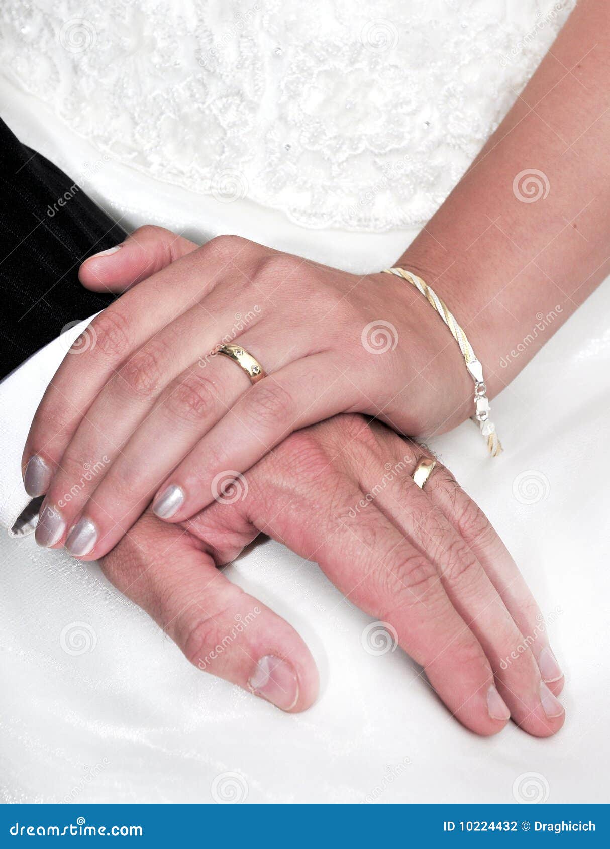 Bride and Groom with Hands Over Wedding Dress Stock Photo - Image of ...