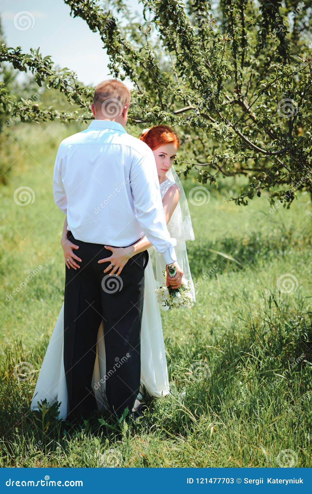 Bride and Groom Hold Each Other Hands while they Walk Along the Stock ... Bride and Groom Hold Each Other Hands while they Walk Along the Stock ...