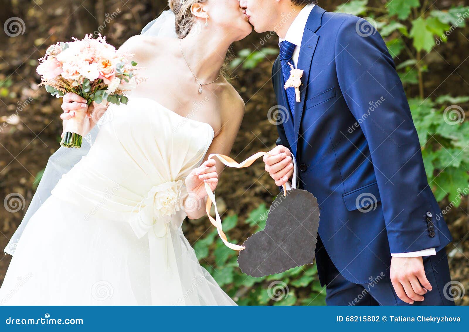 Bride and Groom Holding a Heart Shaped Sign. Stock Photo - Image of ...