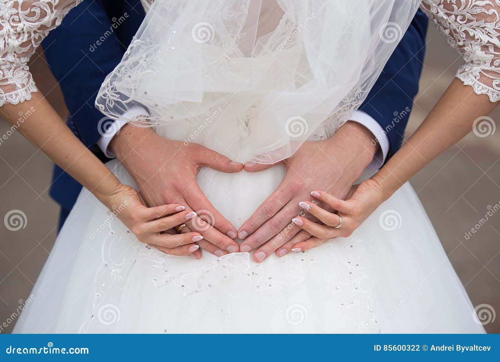Bride and Groom Holding Their Hands in a Heart Shape Stock Photo ...