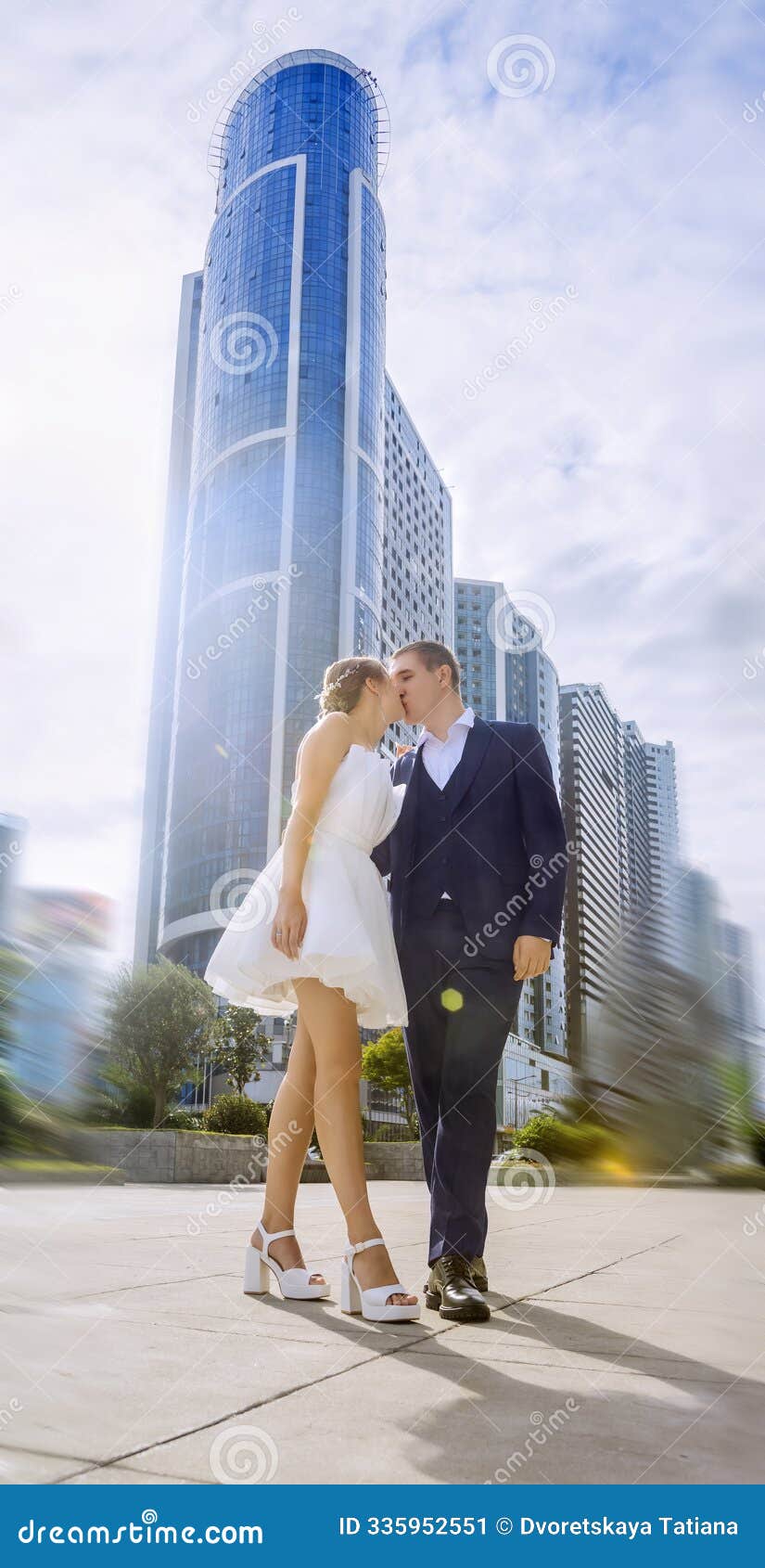 The Bride and Groom Kiss on the Background of a Skyscraper in the Sun ...