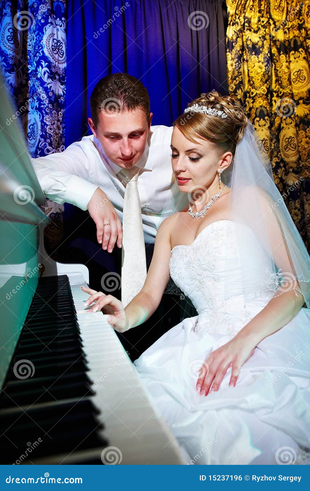 Bride and groom at piano stock photo. Image of play, white - 15237196