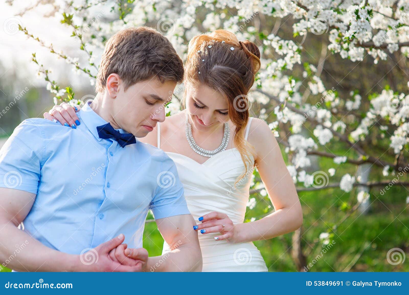 Bride Groom Shows His Biceps on the Background of a Flowering Tree ...