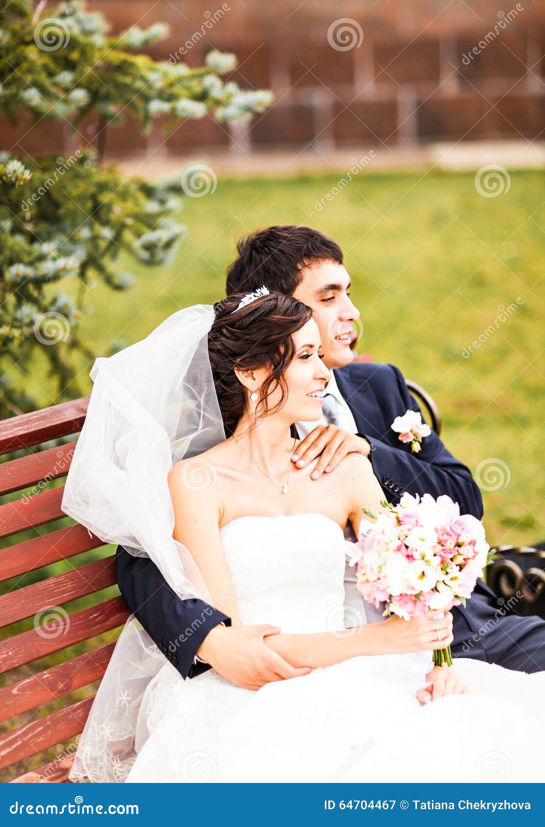 The Bride and Groom Sitting on a Bench in the Park Stock Image - Image ...