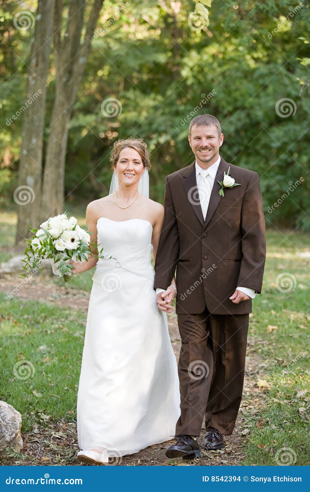 Bride and Groom Walking Along a Path Stock Photo - Image of ceremony ...