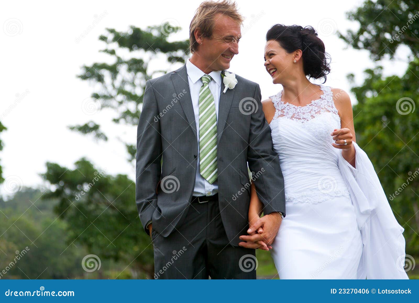 Bride and Groom Walking Holding Hands and Laughing Stock Photo - Image ...
