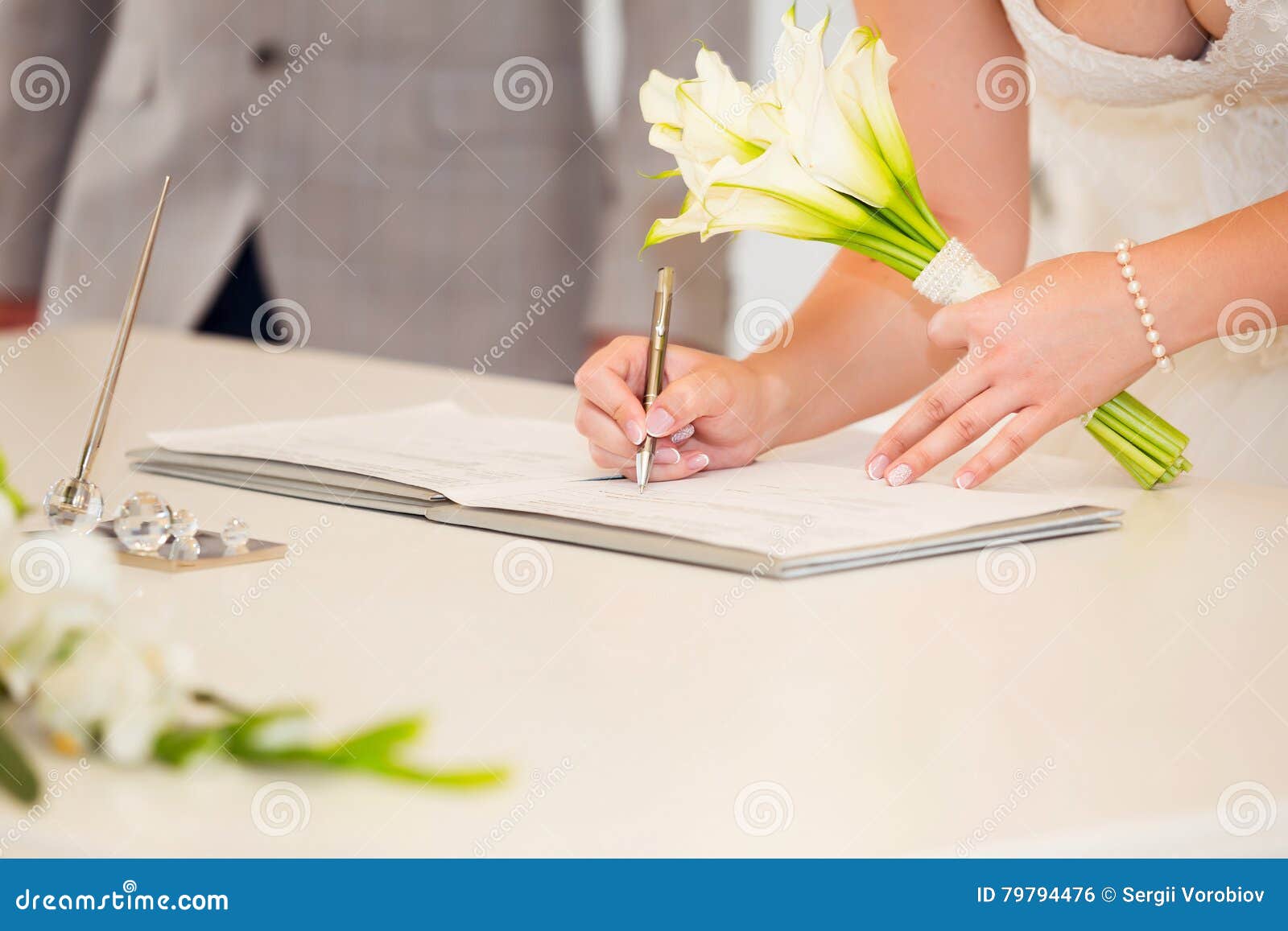 Bride Hand with a Pen Signing Wedding License. Marriage Contract Stock ...