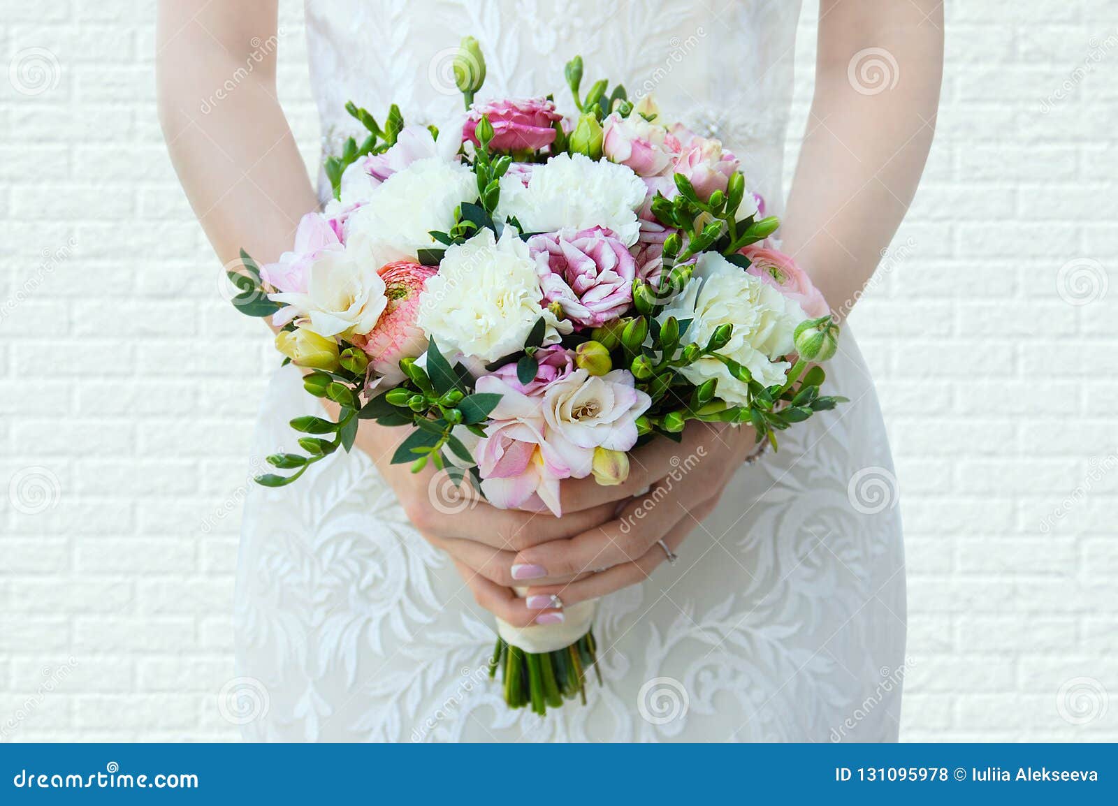 The Bride is Holding a Bouquet of Flowers in Her Hands. Stock Photo ...