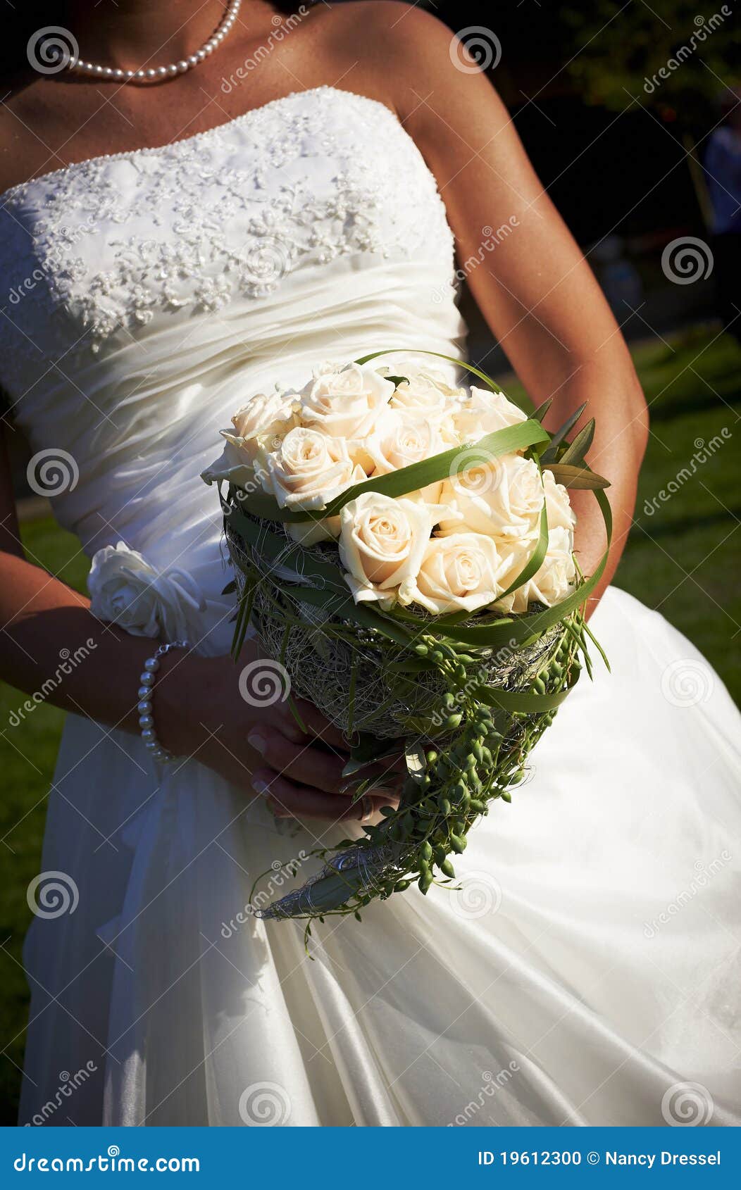 Bride holding rose bouquet stock photo. Image of close - 19612300