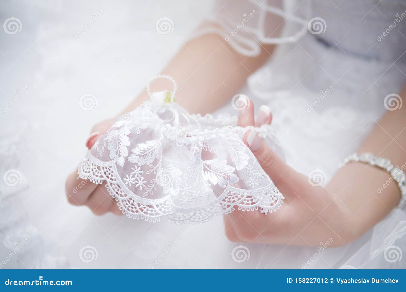 The Bride Holds a Garter in Her Hands Stock Photo - Image of female ...
