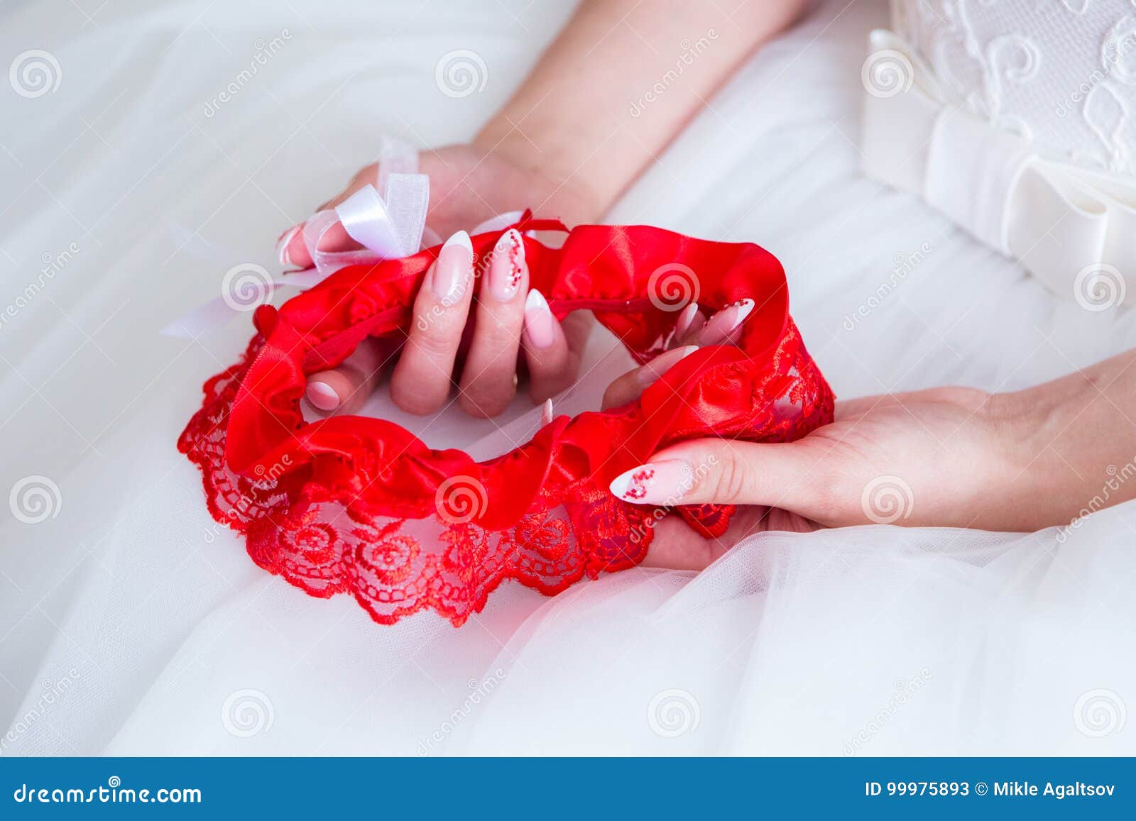 The Bride Holds the Red Garter in the Studio. Stock Image - Image of ...