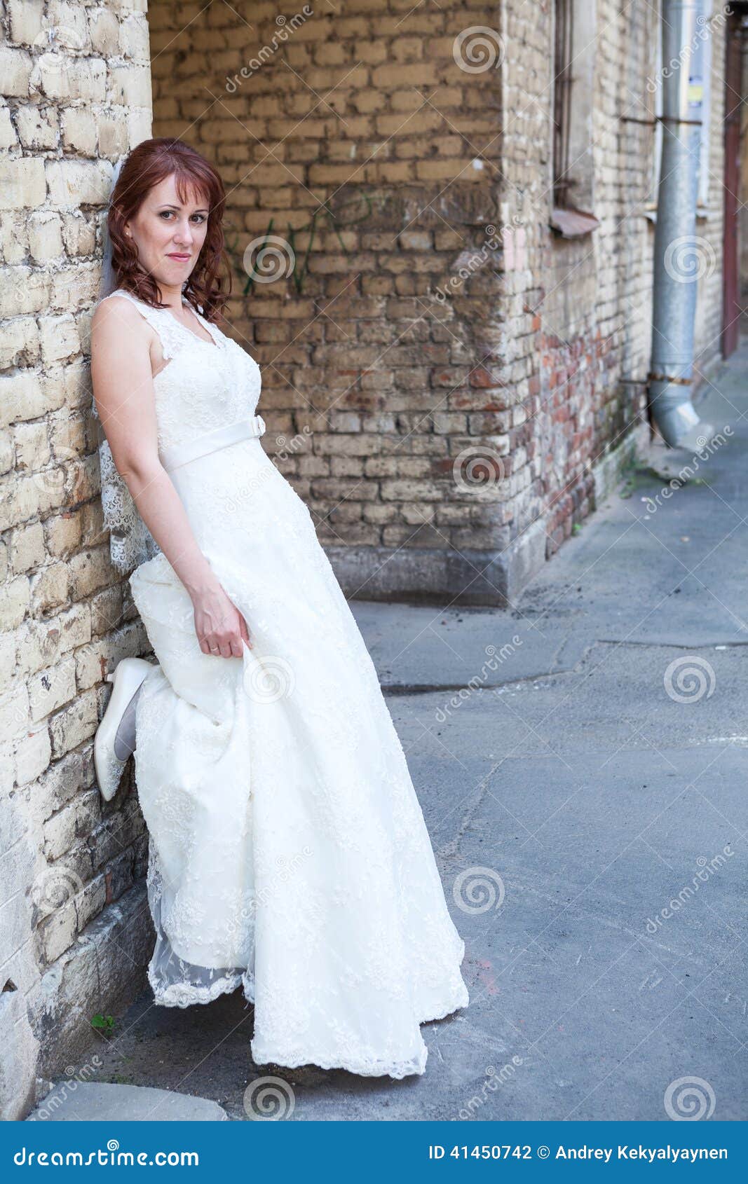 Bride Leaning To Brick Wall Stock Photo - Image of glamour, leaning ...
