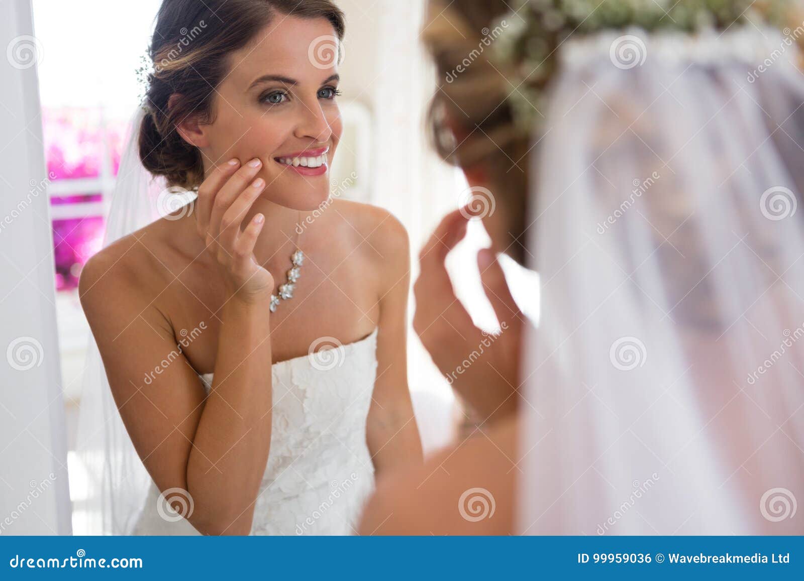 Bride Looking into Mirror while Standing in Fitting Room Stock Photo ...