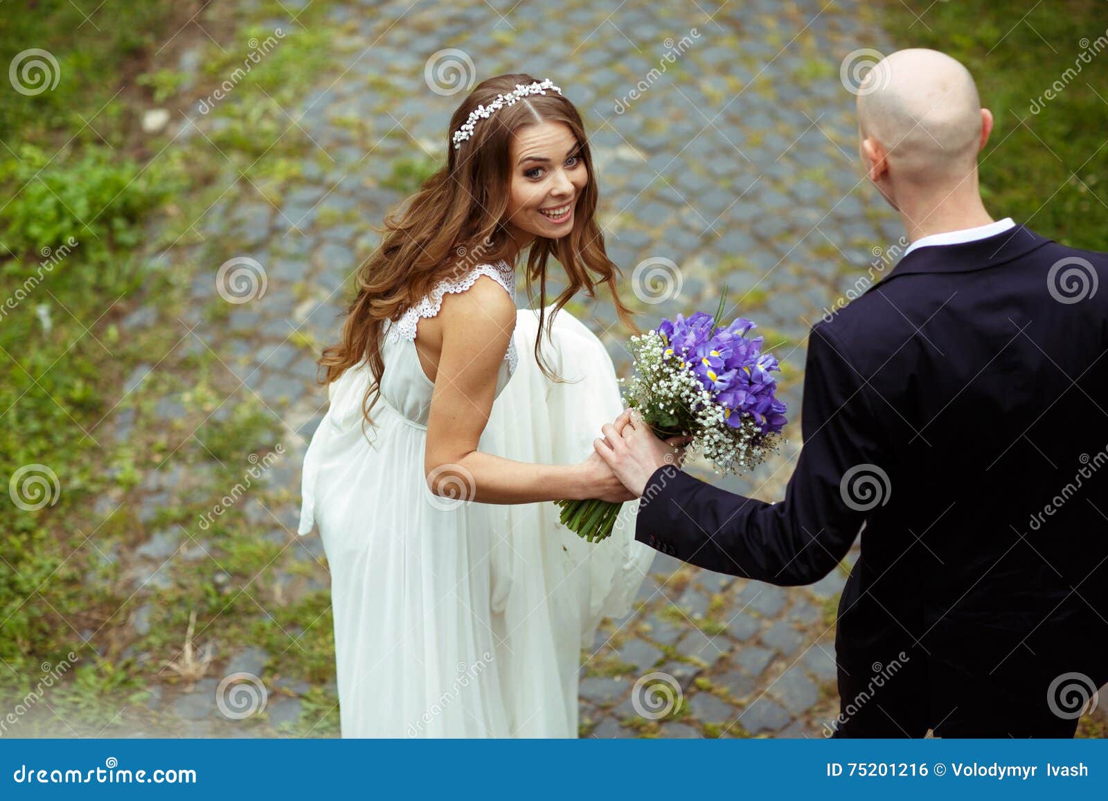 Bride Looks Over Her Shoulder Standing in the Park Stock Photo - Image ...