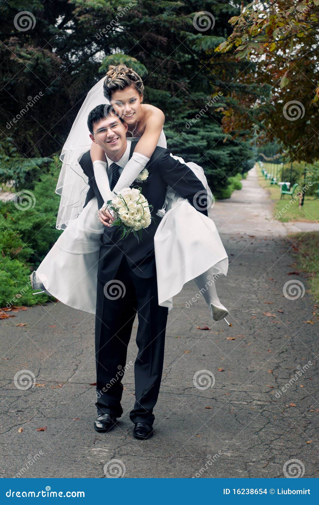 Bride piggyback on groom stock photo. Image of outdoors - 16238654