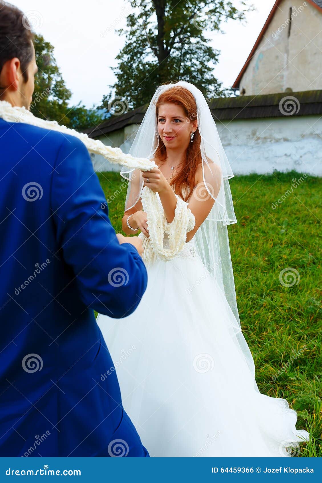 Bride Pulling Her Groom To Her with a Rope - Funny Wedding Concept ...