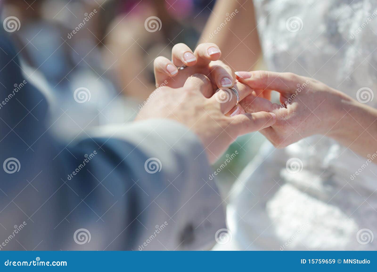 Bride Putting A Wedding Ring On The Finger Of Her Groom During A ...