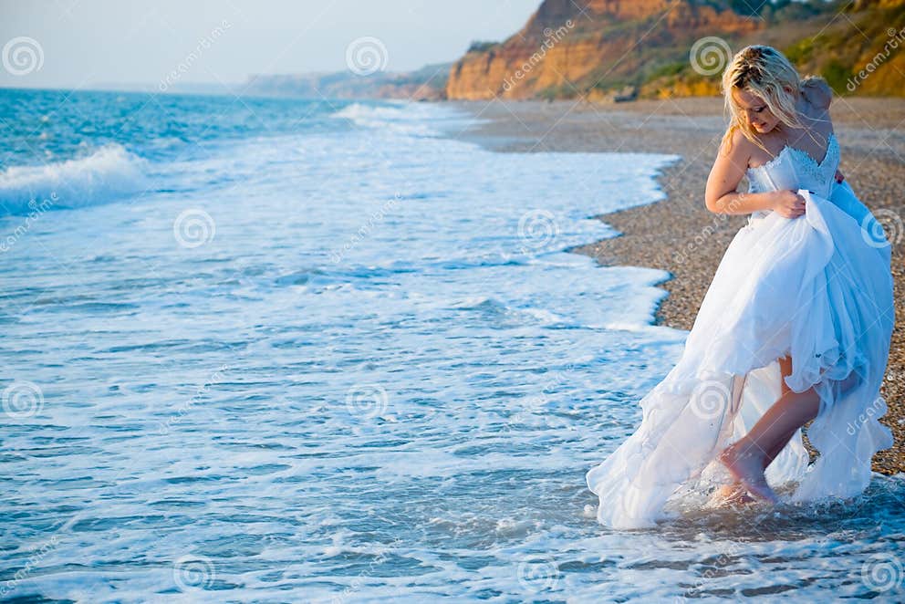 Bride Running Away from Sea Waves Stock Photo - Image of hair, outdoors ...