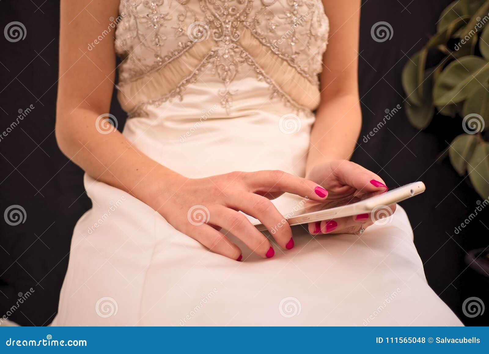 Bride using a mobile stock photo. Image of celebration - 111565048