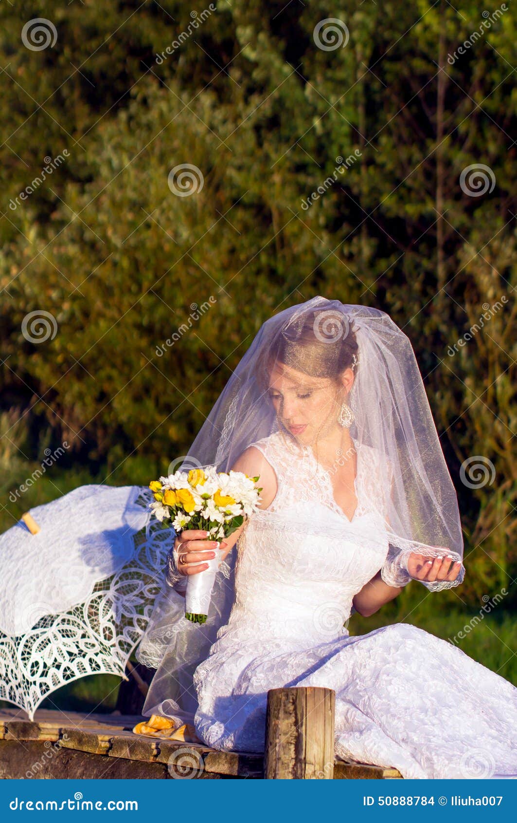 Bride sitting on bridge stock photo. Image of adult, lace - 50888784