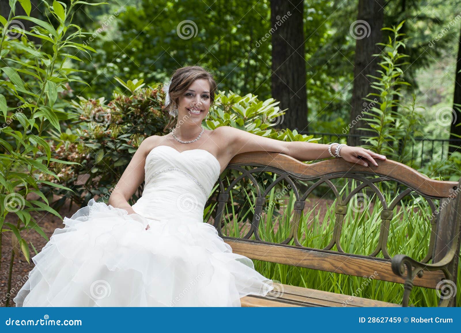 Bride Sitting Outdoors on Bench Stock Image - Image of outside, female ...