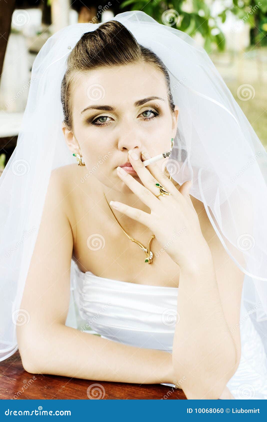 Bride smoking a cigarette stock photo. Image of lips - 10068060