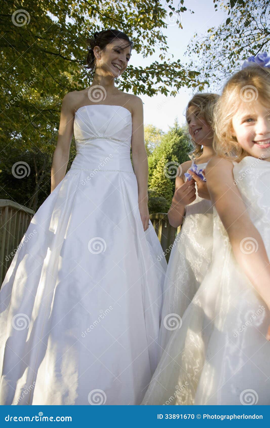 Bride with Two Flower Girls Stock Photo - Image of gown, enjoyment ...