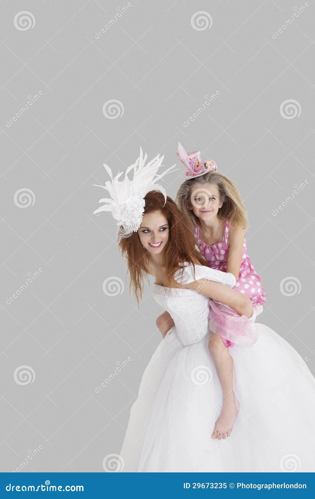 Bridesmaid Getting a Piggyback Ride from Young Bride Over Gray ...