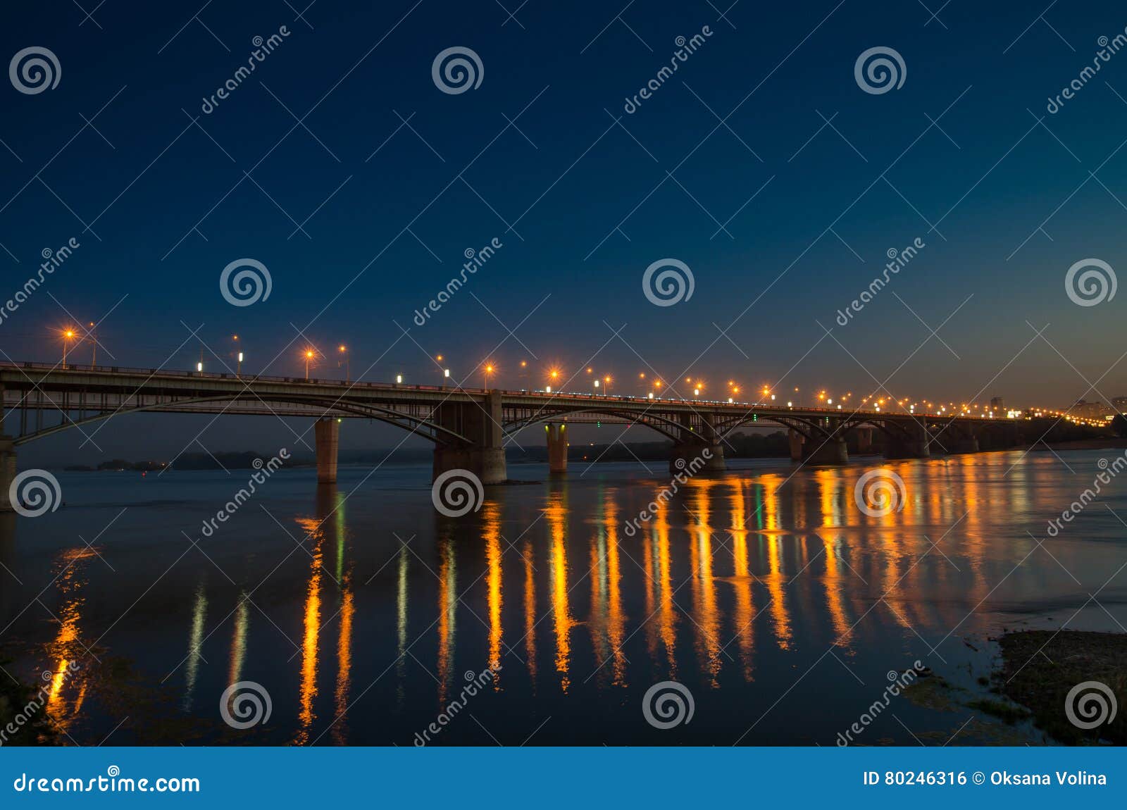 Bridge with Bright Lights Across the River at Night and Reflection ...