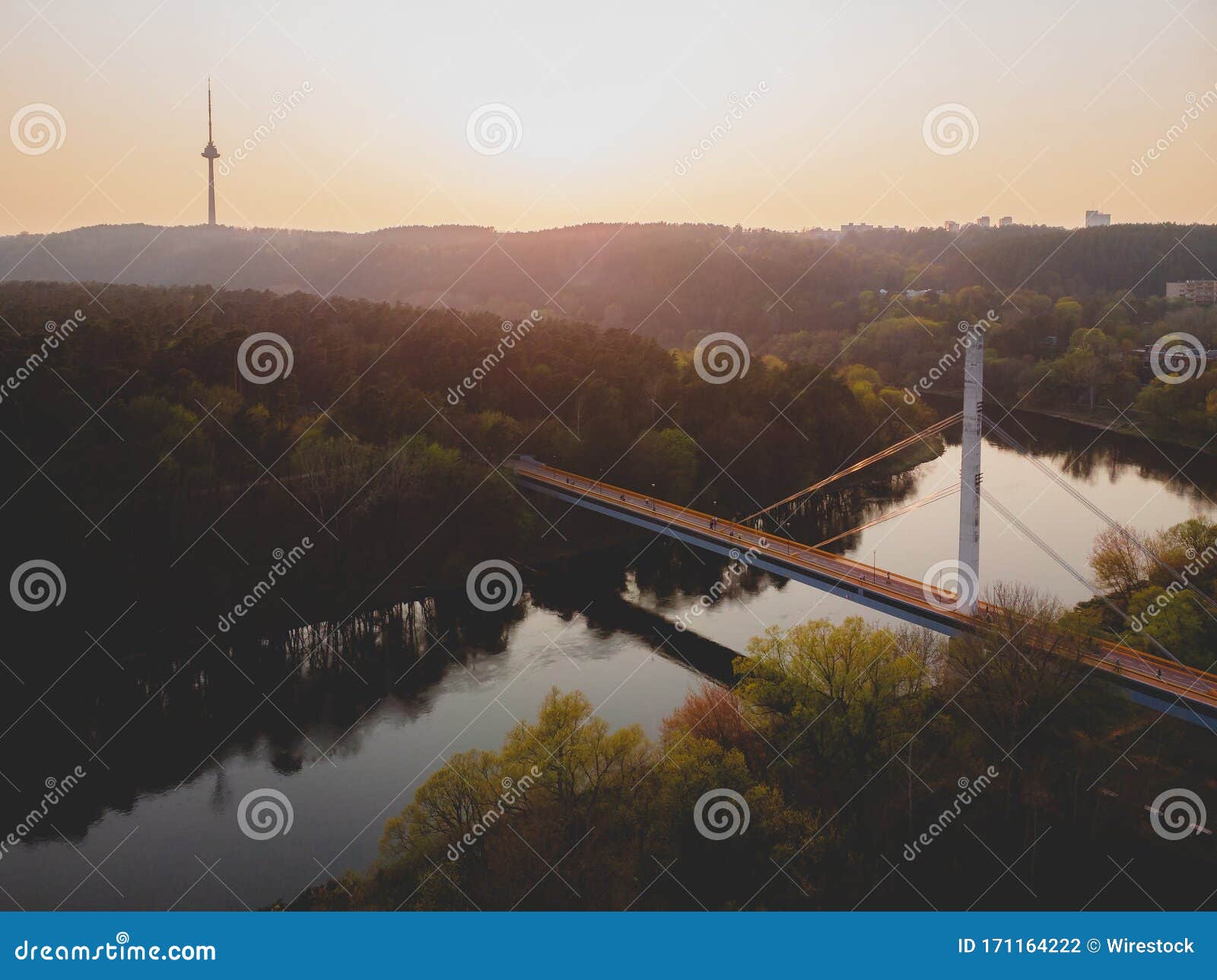 Bridge Connecting Two Shores of the River and a Tower on the Background ...