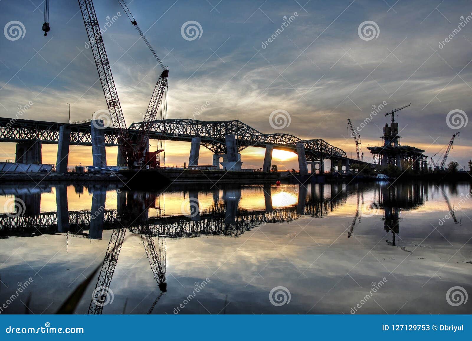 Bridge Construction at Sunset with Water Reflection Stock Image - Image ...