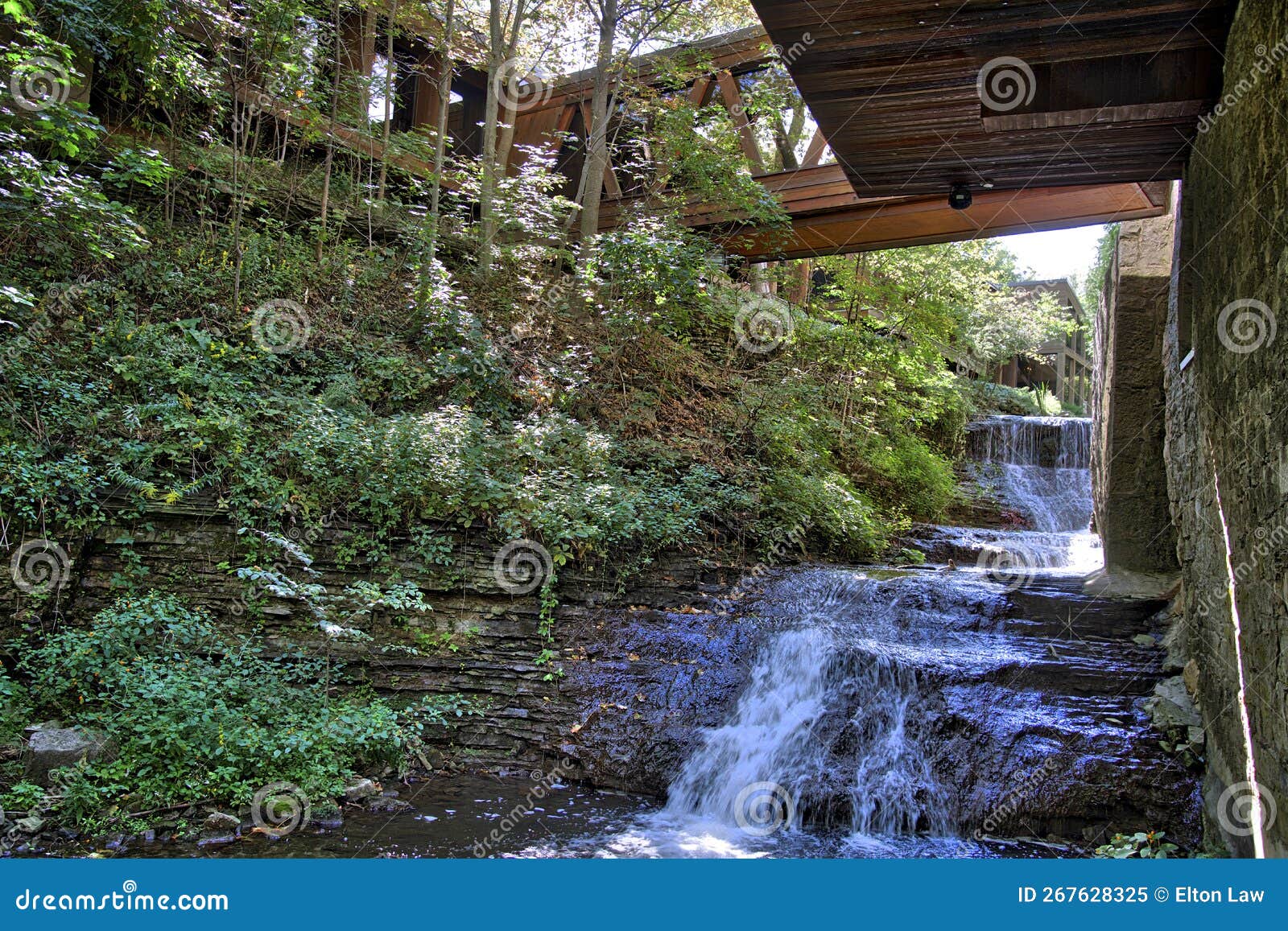 A Bridge Cross Over Two Buildings with a Waterfall View Stock Image ...