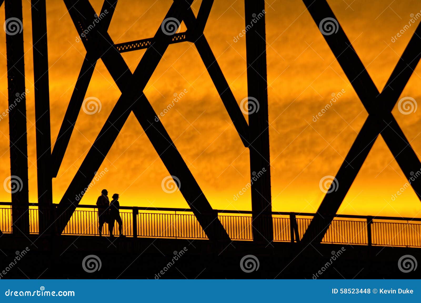 Couple Walking on Bridge at Sunset Stock Photo - Image of people ...