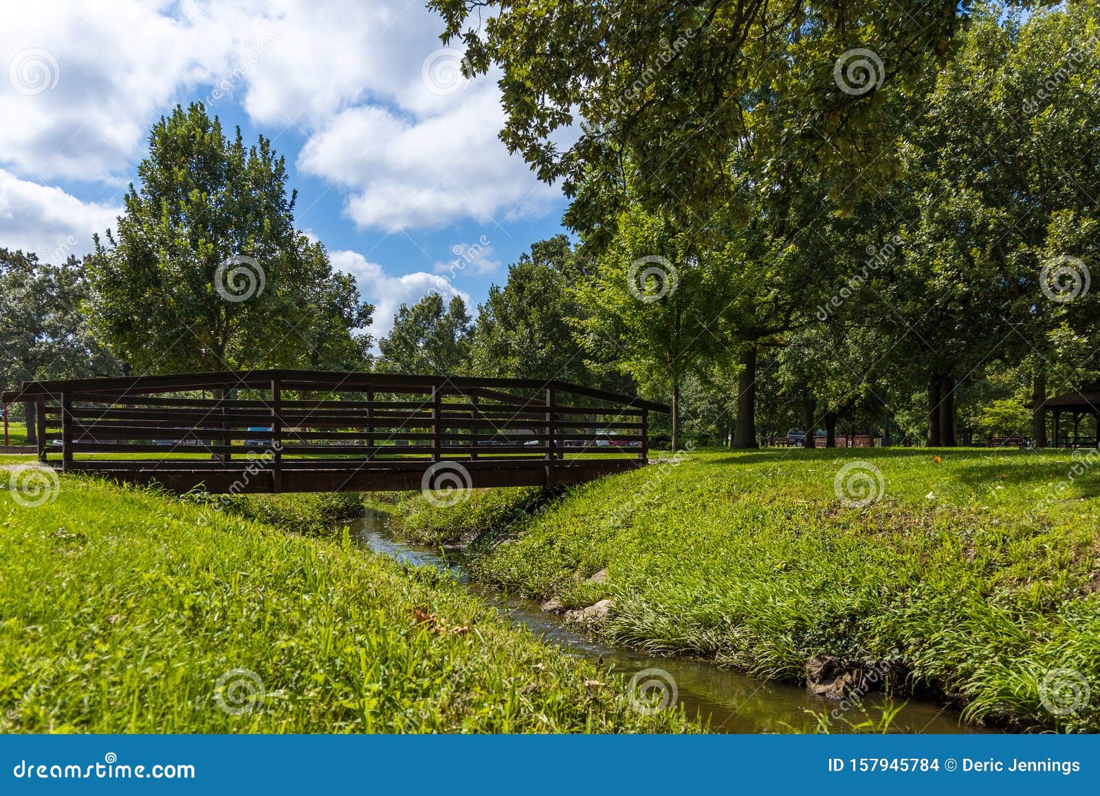 Bridge Over a Creek Running through a Park Stock Photo - Image of field ...