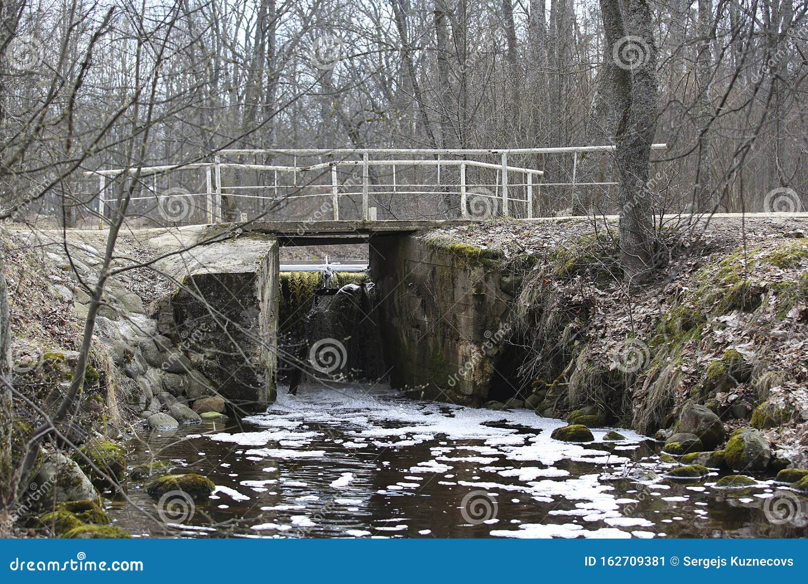 Bridge Over a Creek with a Waterfall Stock Image - Image of backlit ...