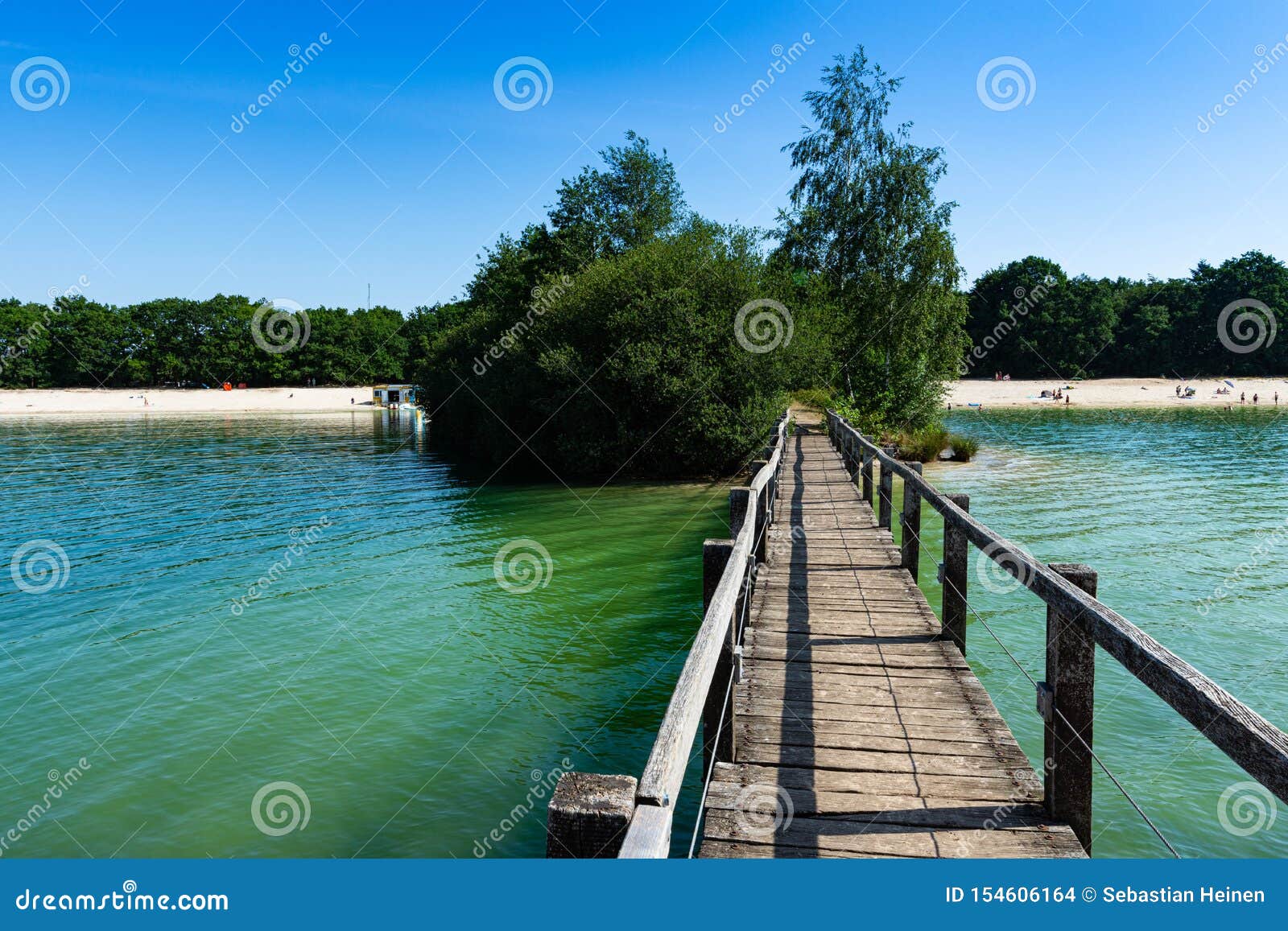 Bridge Over the Lake with a Beach in the Background Stock Photo - Image ...