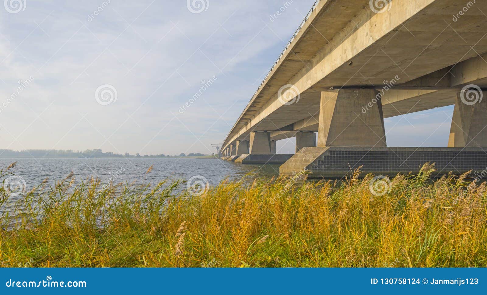 Bridge Over a Lake in Sunlight at Fall Stock Photo - Image of shore ...