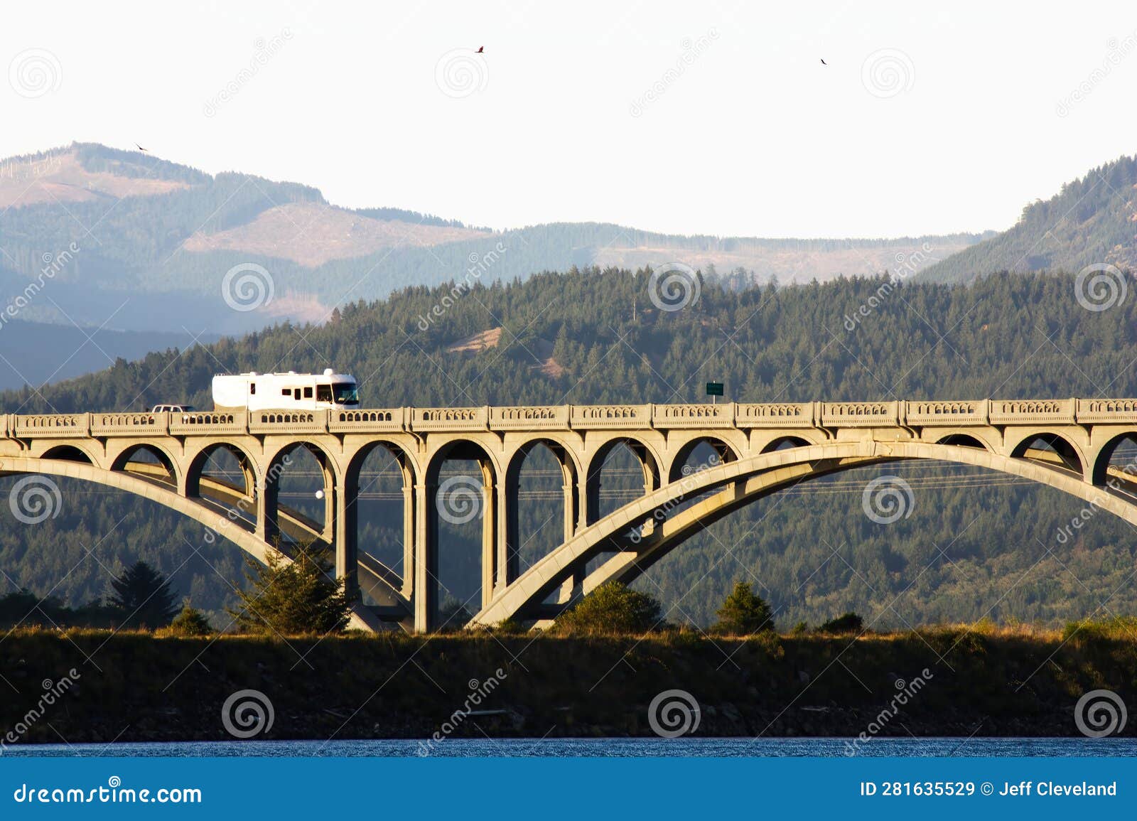 Bridge Over Rogue River Oregon with Hills and Sky Stock Image - Image ...