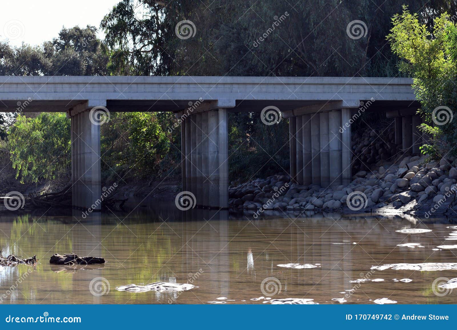 A Bridge Over Small Shallow Stream and Rocky Landscape Stock Photo ...