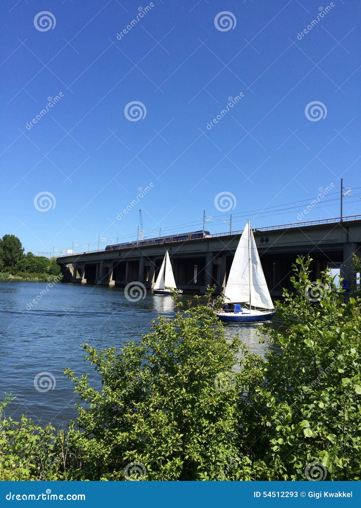 Bridge Over Water with Train and Boats Passing Under the Bridge Stock ...