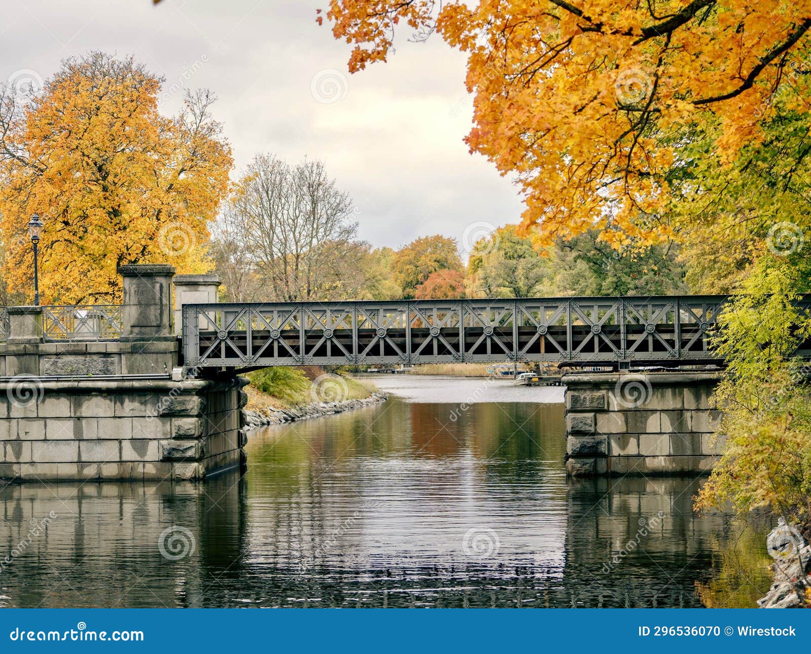 A Bridge Over Water Under an Orange Tree with Fall Foliage Stock Photo ...
