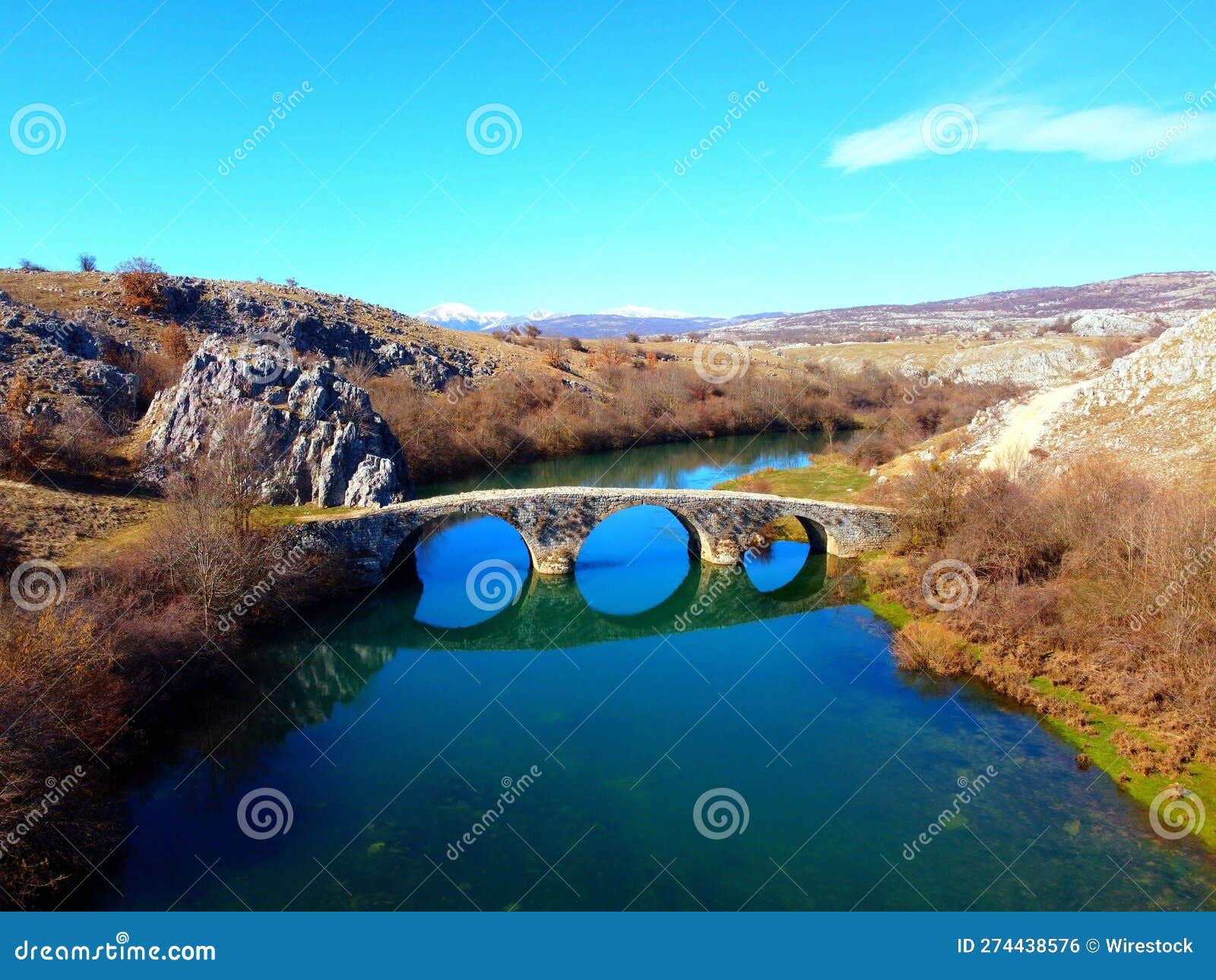 Bridge Provides Passage Over a Pristine River Running through a Lush ...