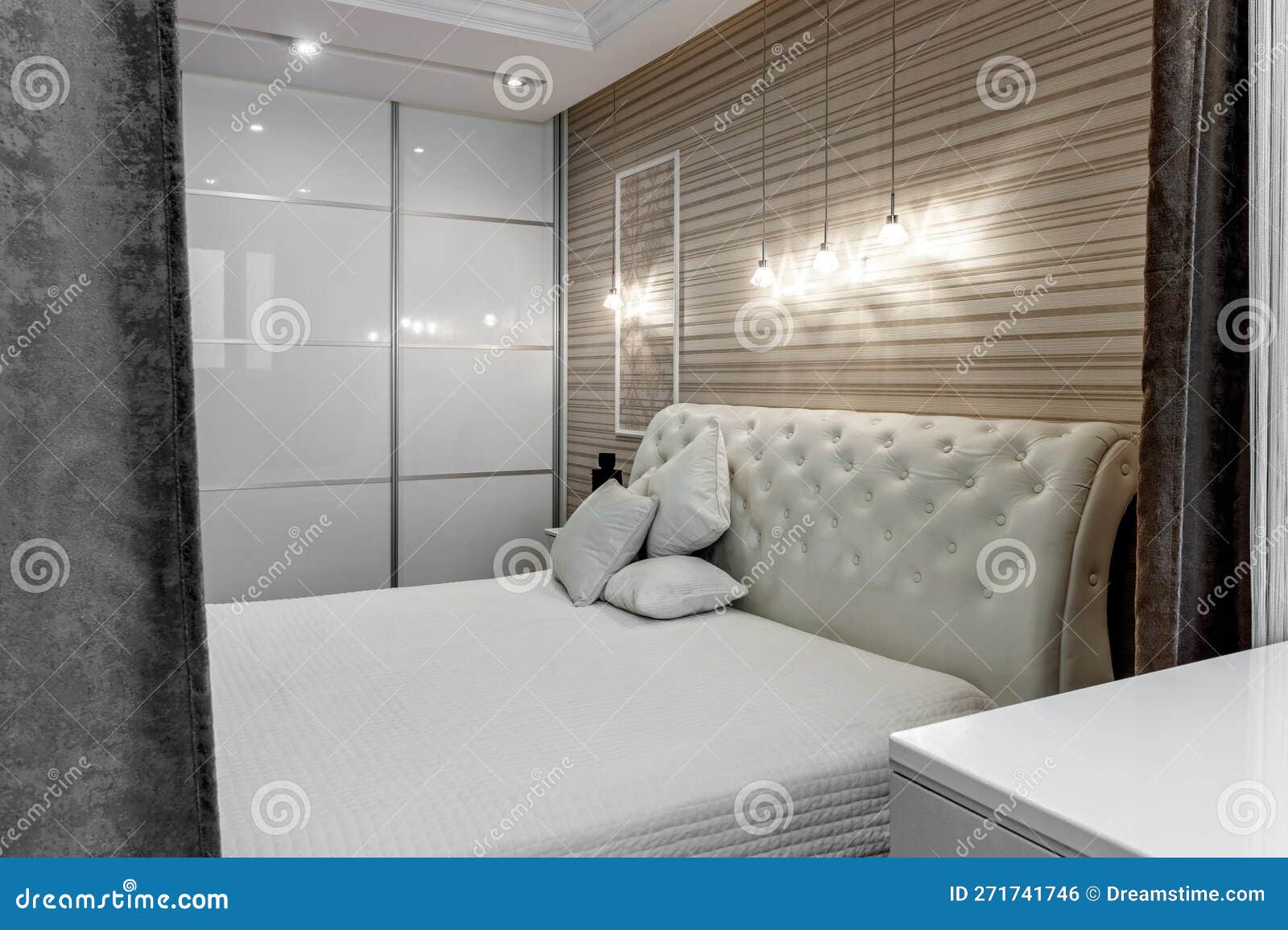 Bright Bedroom with Large White Bed and Capitone Headboard Stock Photo ...