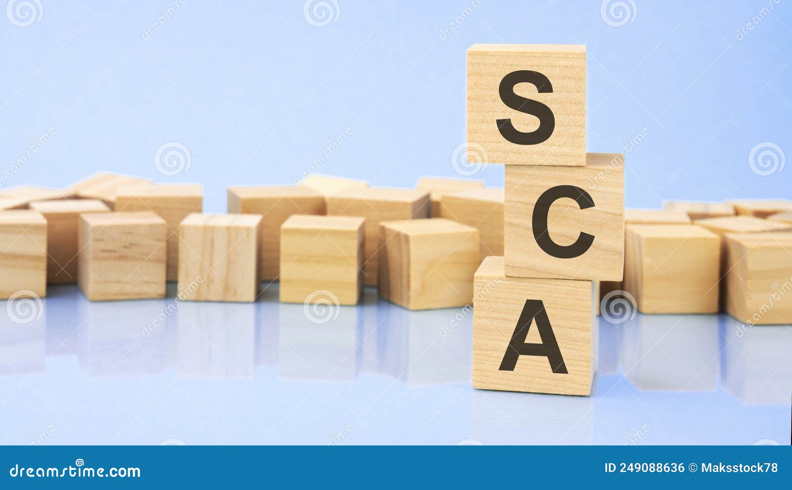 On a Bright Blue Background, Light Wooden Blocks and Cubes with the ...