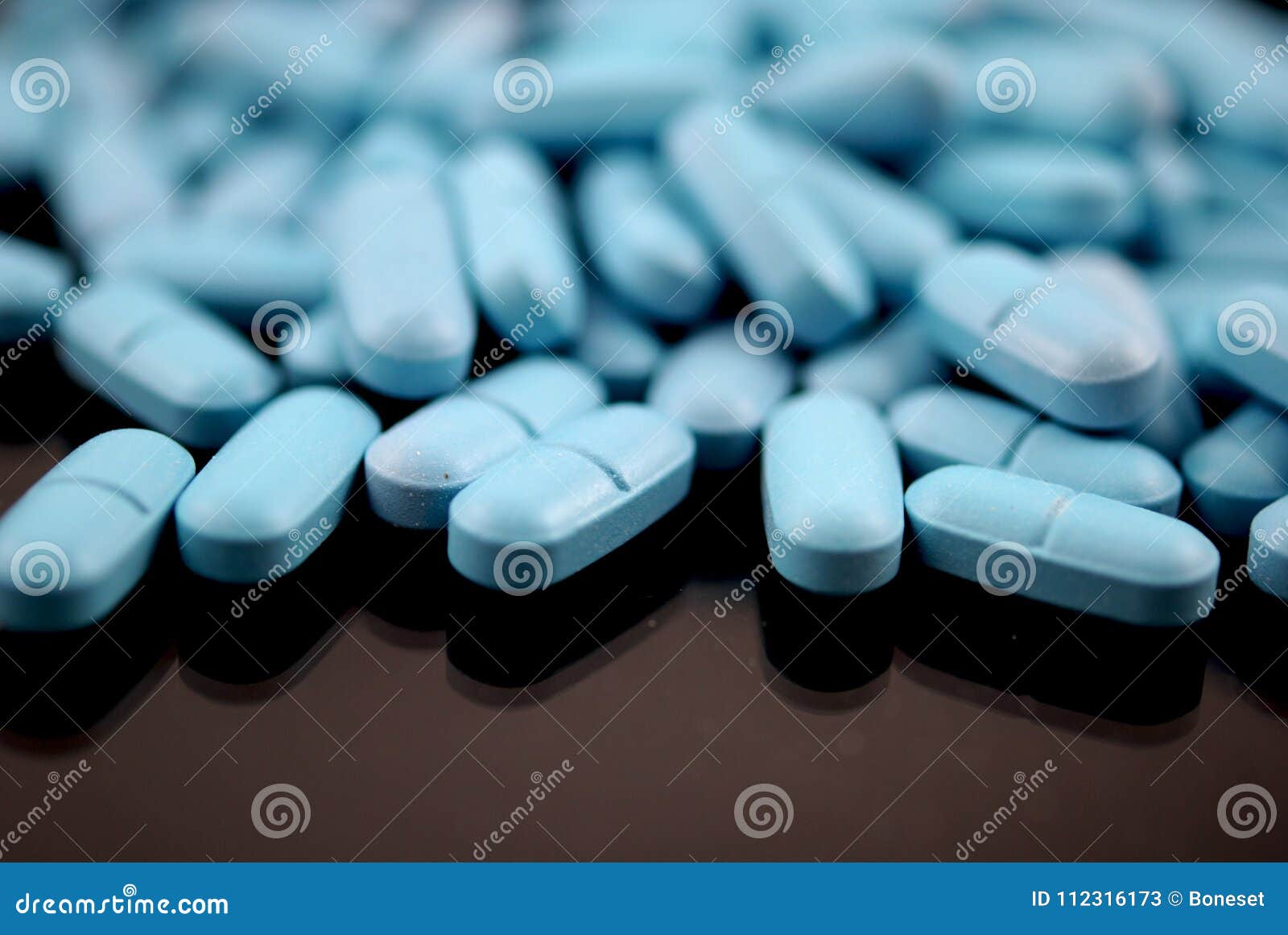 Bright blue oval tablets stock image. Image of healthy - 112316173