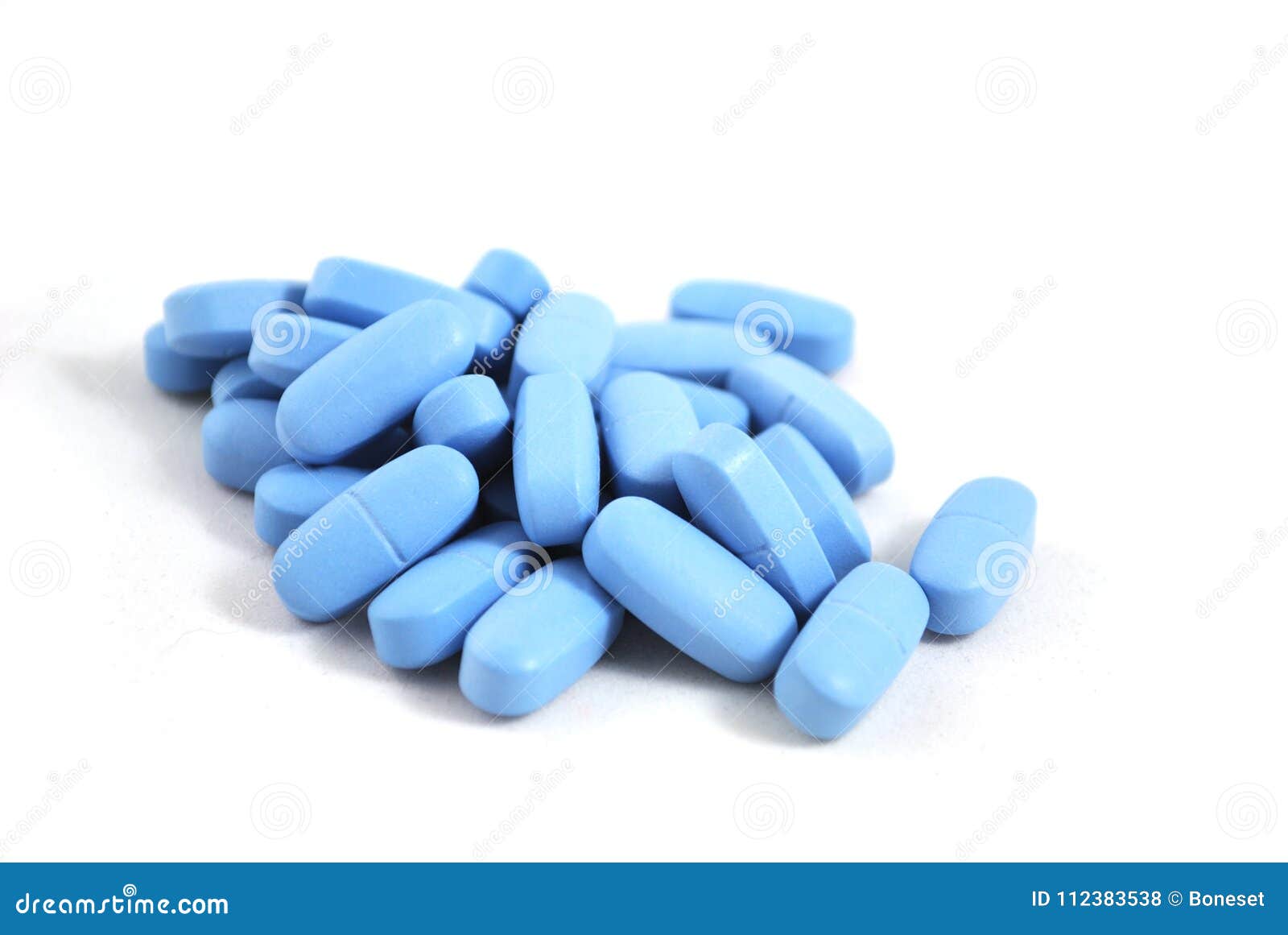 Bright blue oval tablets stock photo. Image of dose - 112383538