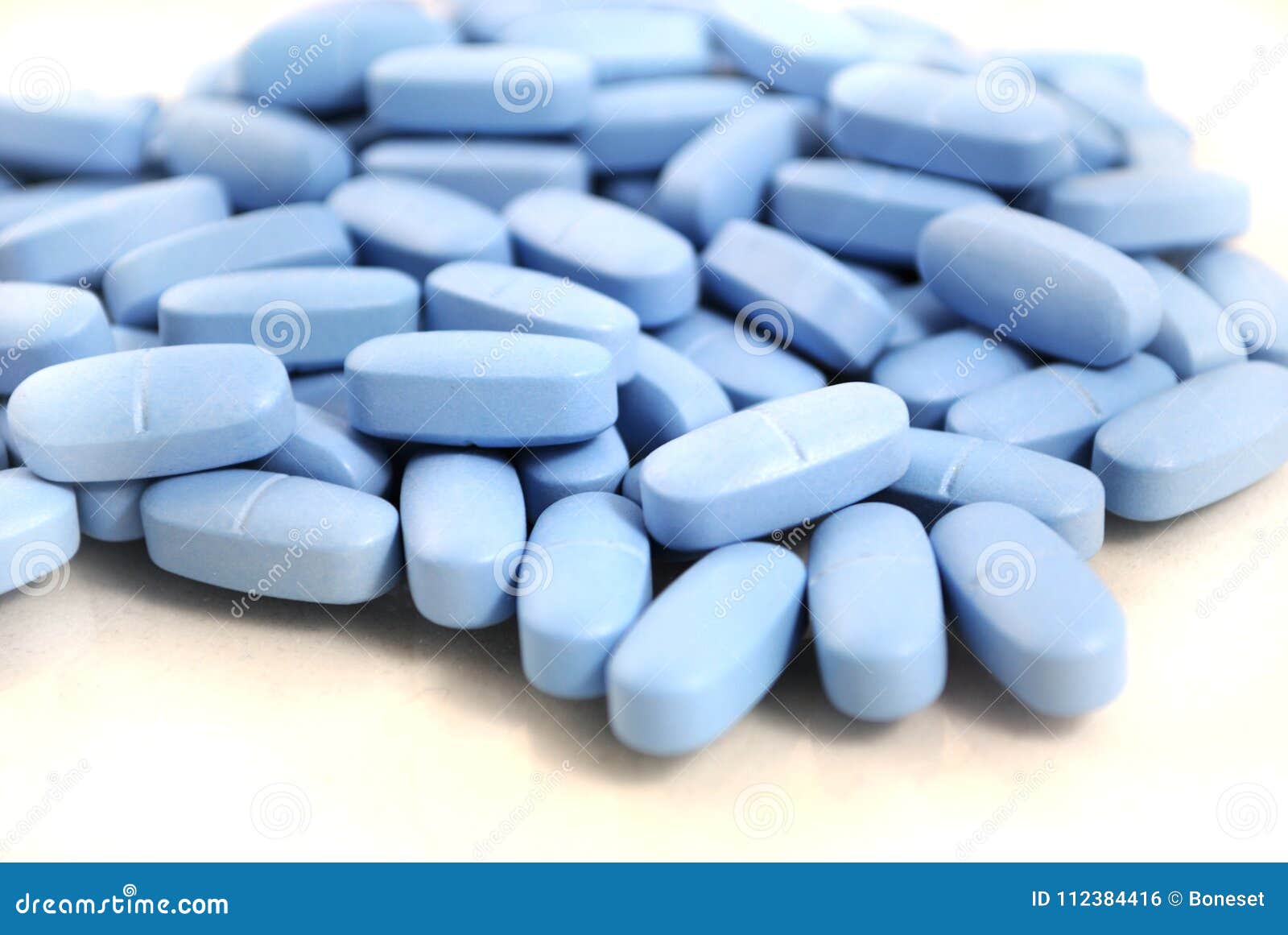Bright blue oval tablets stock photo. Image of pain - 112384416