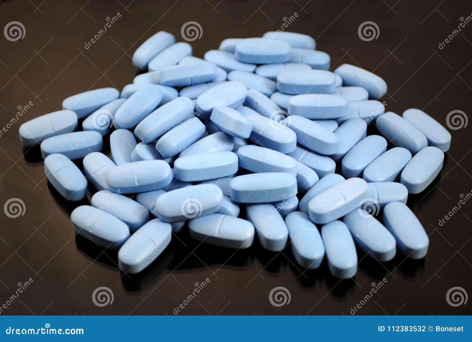 Bright blue oval tablets stock photo. Image of medication - 112383532